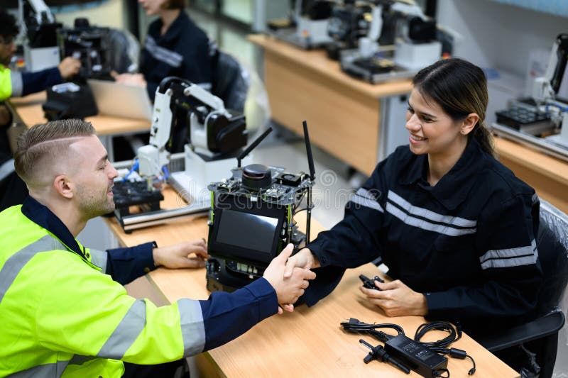 Group of Maintenance Engineers Checking and Repairing Automatic Robotic ...