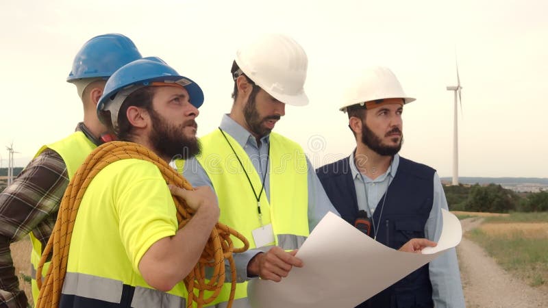 Group of Caucasian Male Engineers Looking at a Blueprint in a Windmill ...