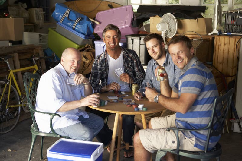 Group of Male Friends Playing Cards in Garage Stock Image - Image of ...