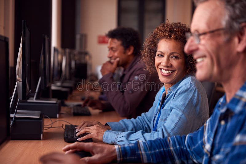 Group of Mature Adult Students in Class Working at Computers in College ... Group of Mature Adult Students in Class Working at Computers in College ...