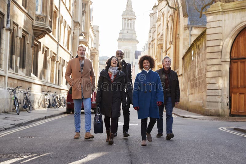 Group of Mature Friends Walking through City in Fall Together Stock ...