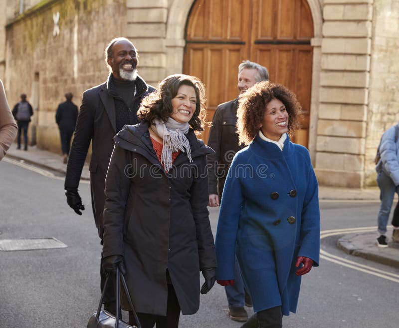 Group of Mature Friends Walking through City in Fall Together Stock ...