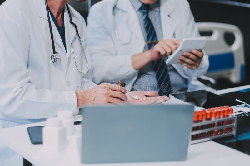 Group of Medical Practitioners Working Together and Analyzing Medical ...