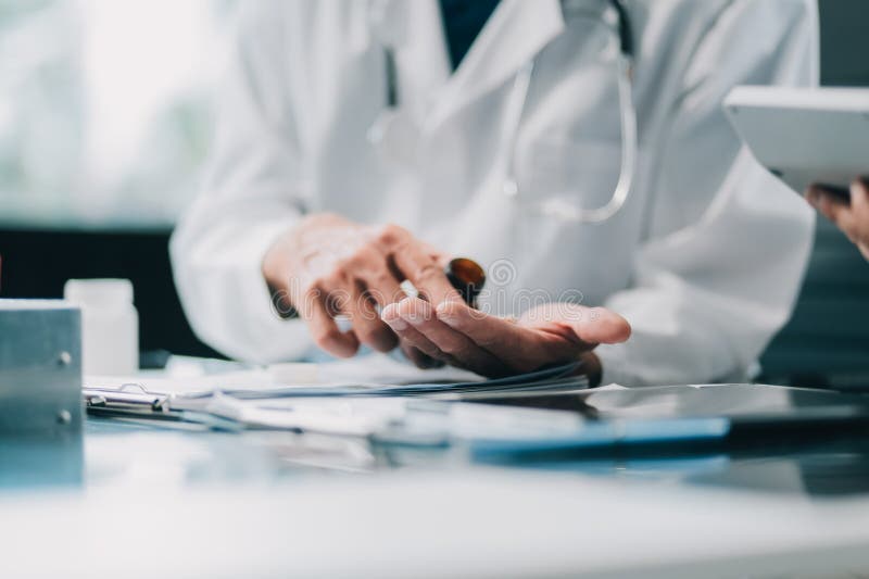 Group of Medical Practitioners Working Together and Analyzing Medical ...