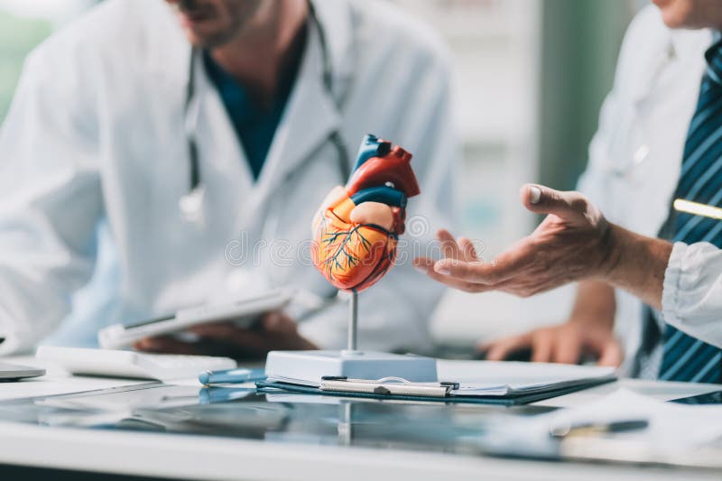 Group of Medical Practitioners Working Together and Analyzing Medical ...