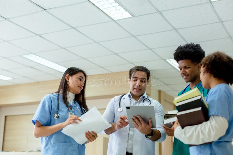 Group of Medical Student and Teacher Standing Looking Work in Tablet ...