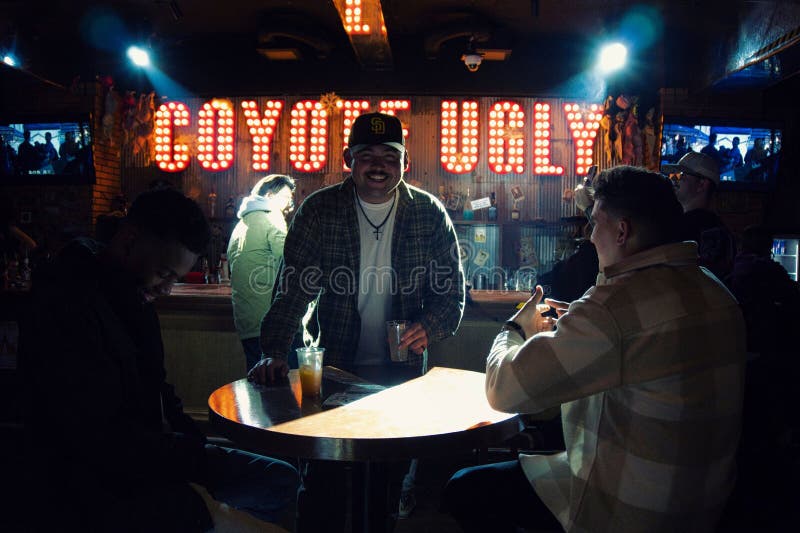 Group of Men Enjoying Drinks at a Bar while Seated in a Social Setting ...