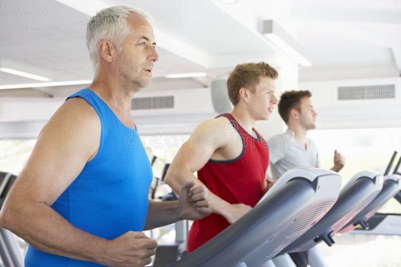 Group of Men Using Running Machines in Gym Stock Image - Image of ...