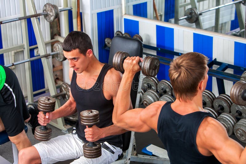 Group Men Working His Arms with Dumbbells at Gym Stock Image - Image of ...