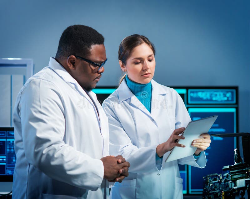 Group of Microelectronic Engineers Discussing in a Modern ...