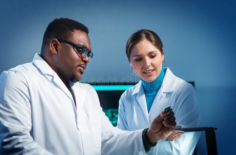 Group of Microelectronic Engineers Discussing in a Modern ...