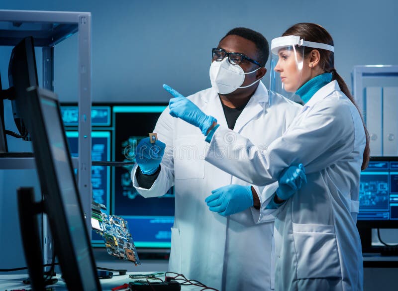 Group of Microelectronic Engineers Discussing in a Modern ...