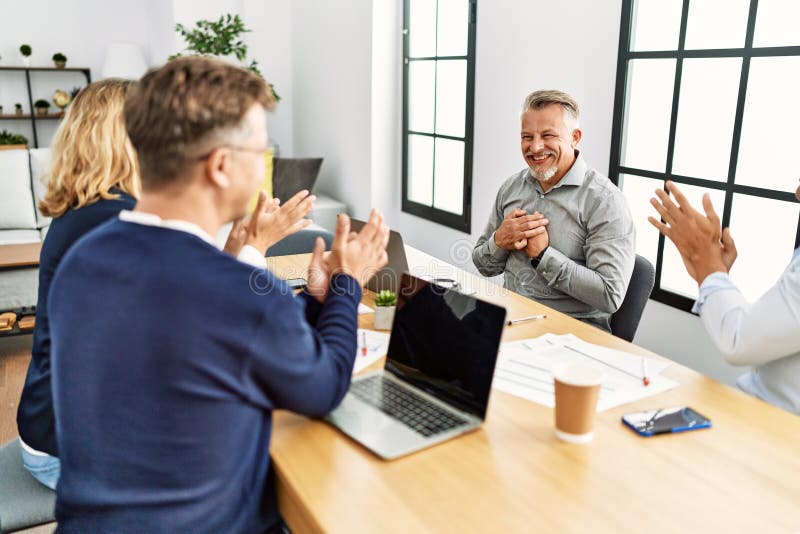 Group of Middle Age Business Workers Smiling and Clapping To Partner at ...