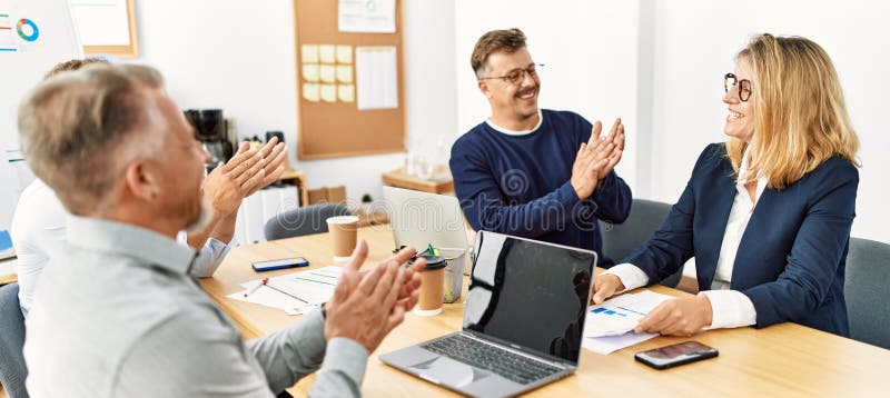 Group of Middle Age Business Workers Smiling and Clapping To Partner at ...