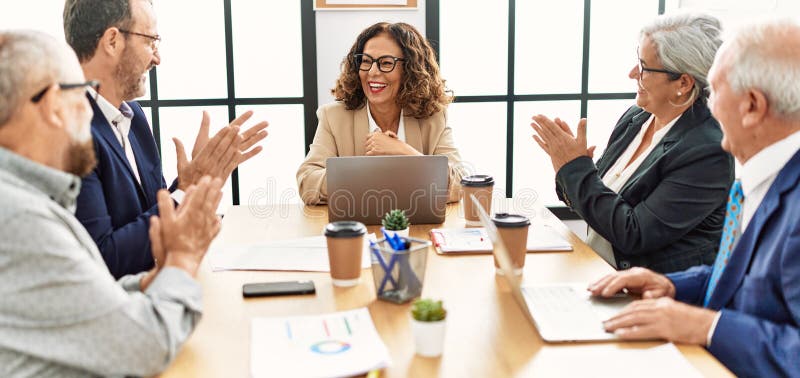Group of Middle Age Business Workers Smiling and Clapping To Partner at ...