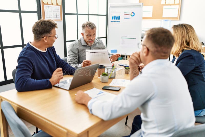 Group of Middle Age Business Workers Working at the Office Stock Image ...
