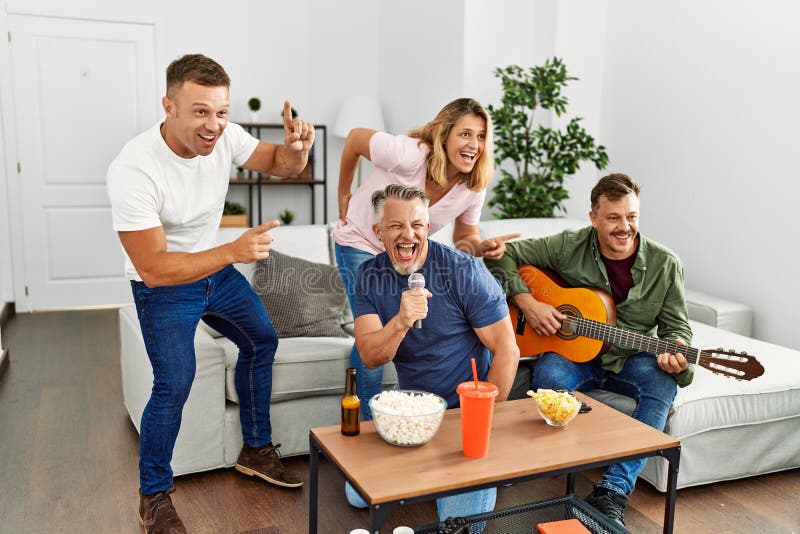 Group of Middle Age Friends on Party Singing and Playing Guitar at Home ...