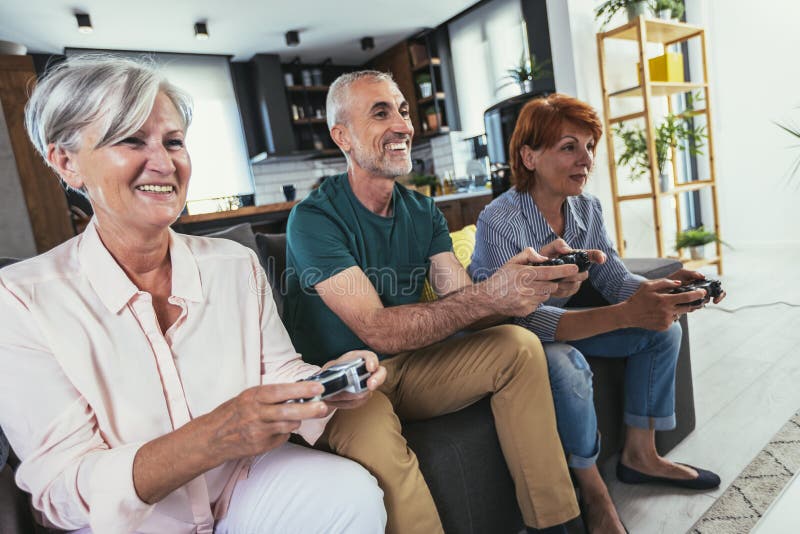 Middle Age Friends Smiling Happy Playing Video Game at Home Stock Photo ...