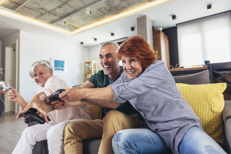 Middle Age Friends Smiling Happy Playing Video Game at Home Stock Photo ...