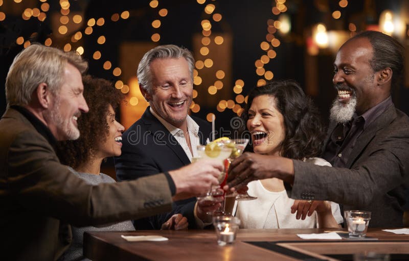 Group of Middle Aged Friends Celebrating in Bar Together Stock Image ...