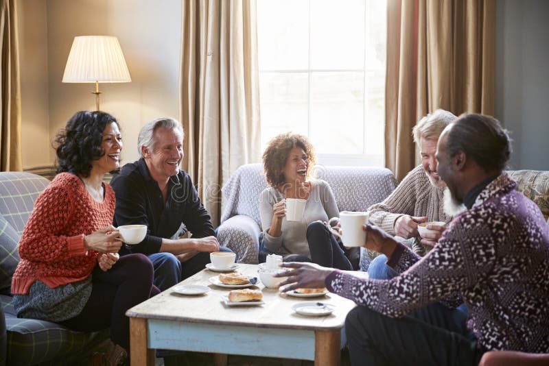 Group of Middle Aged Friends Meeting Around Table in Coffee Shop Stock ...