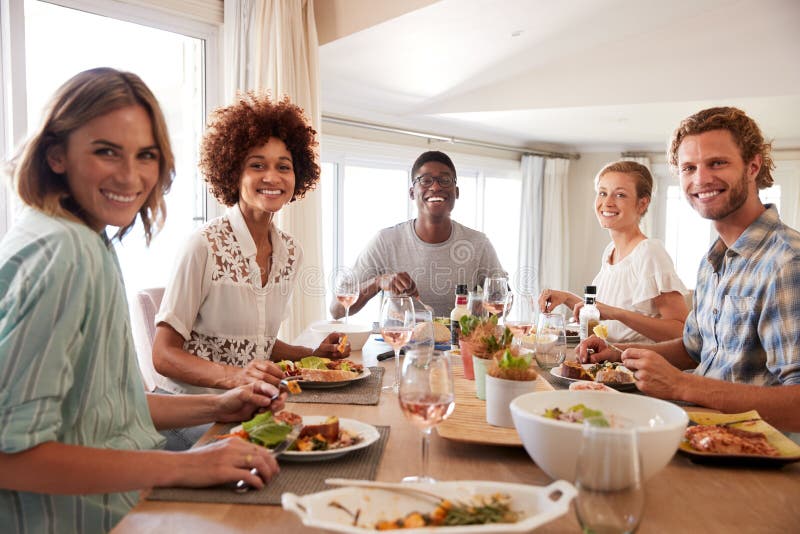 A Group of Millennial Friends Sitting at a Table Eating Lunch, Looking ...