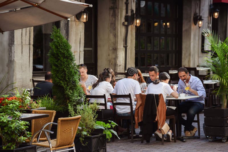 Group of Millennials Eating Dinner Outside at Upscale Restaurant ...