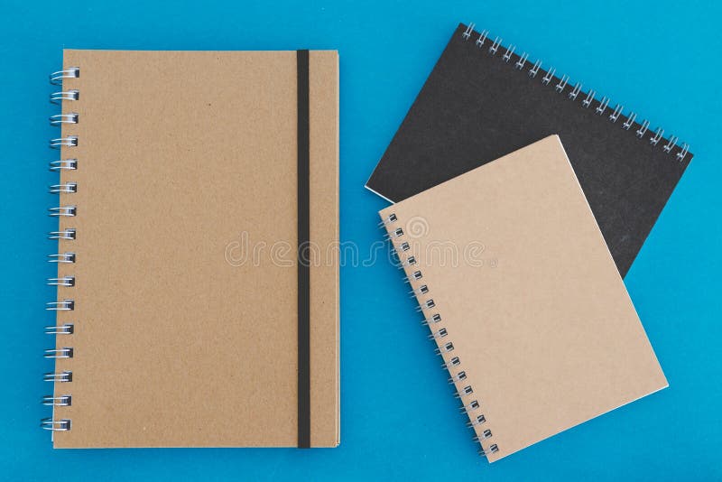 Group of Minimalist Looking Notebooks of Different Shapes on Blue Stock ...