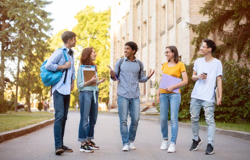 Group of Mixed Students Walking Together Talking during Break Outside ...