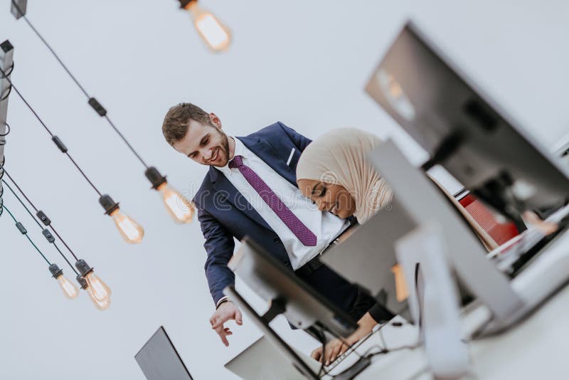 Group of Multi-ethnic Colleagues Working on Desktop Computers, Laptop ...