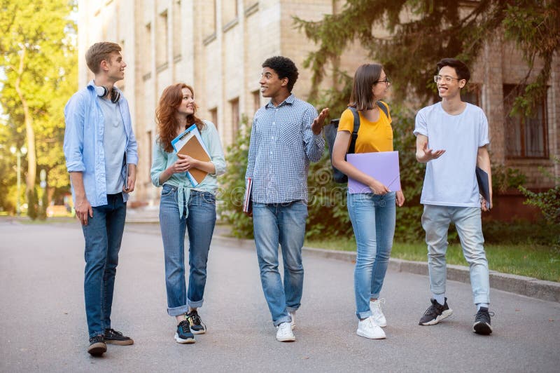 Group of Multicultural First-Year Students Walking Near University ...