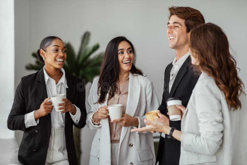 Group of Multiethnic Colleagues Standing with Cups of Coffee and ...