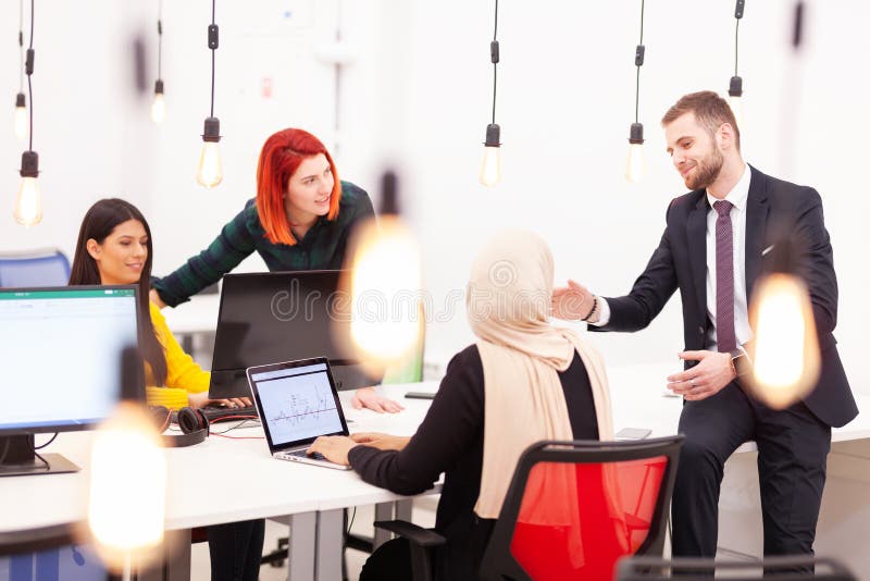 Group of Multiethnic Colleagues Working on Desktop Computers in a ...