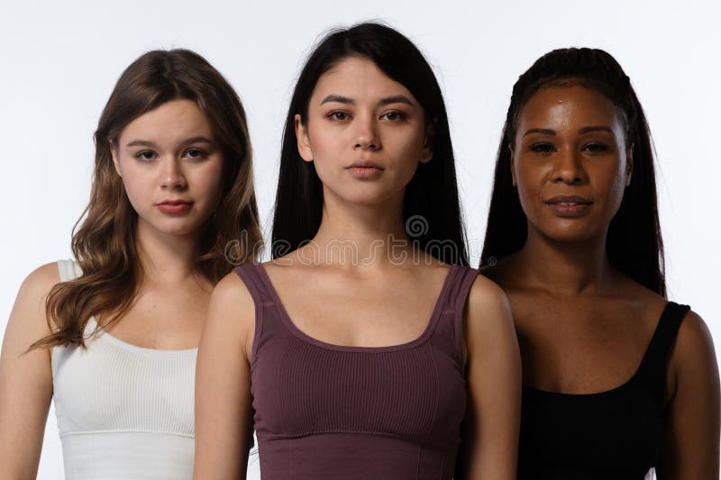 Three Positive Multiracial Young Women Posing at Camera with Confident ...