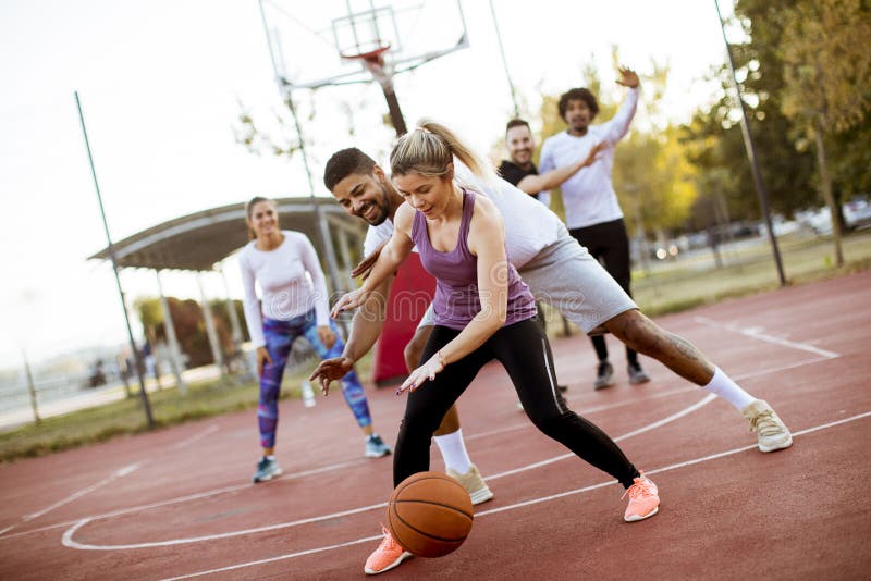 Group of Multiethnic People Playing Basketball on Court Stock Photo ...