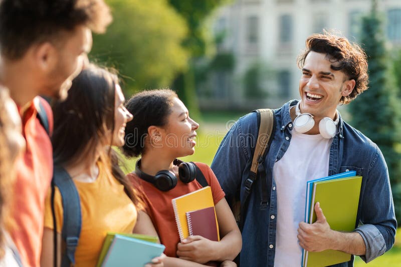 Group of Multiethnic Students Resting in Campus Outdoors during Break ...