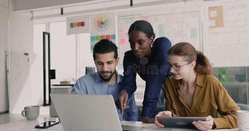 Group of Multiethnic Young and Skilled Workmates Using Modern Devices ...