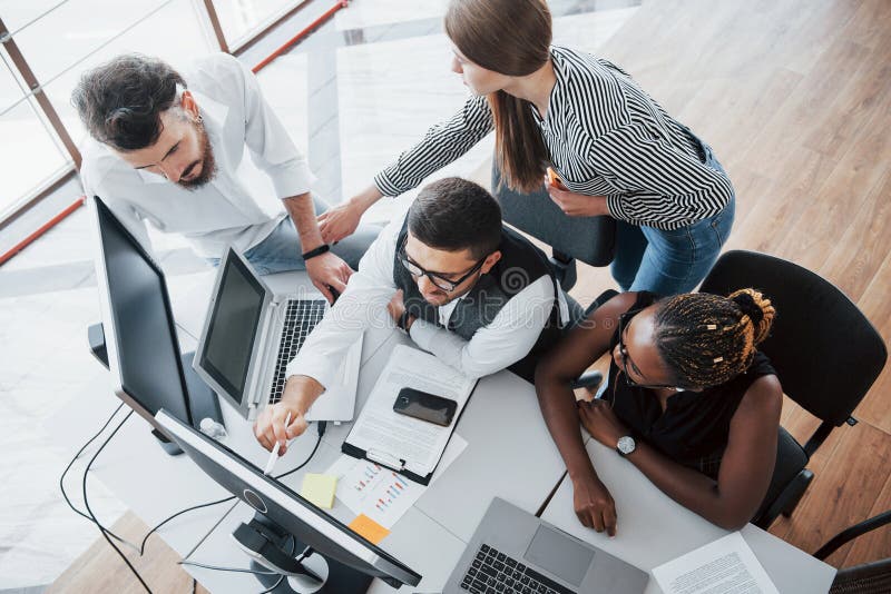 A Group of Multinational Busy People Working in the Office. Stock Photo ... A Group of Multinational Busy People Working in the Office. Stock Photo ...