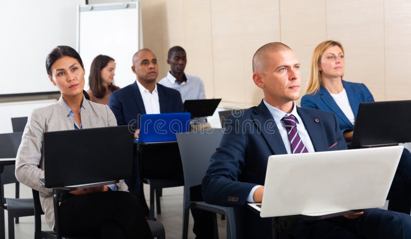 Group of Multinational People Working on Laptops during Business ... Group of Multinational People Working on Laptops during Business ...