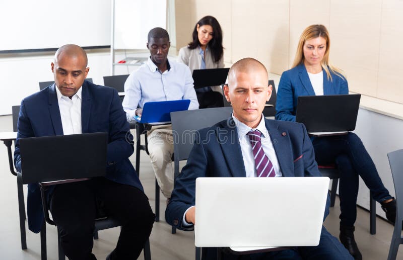 Group of Multinational People Working on Laptops during Business ... Group of Multinational People Working on Laptops during Business ...
