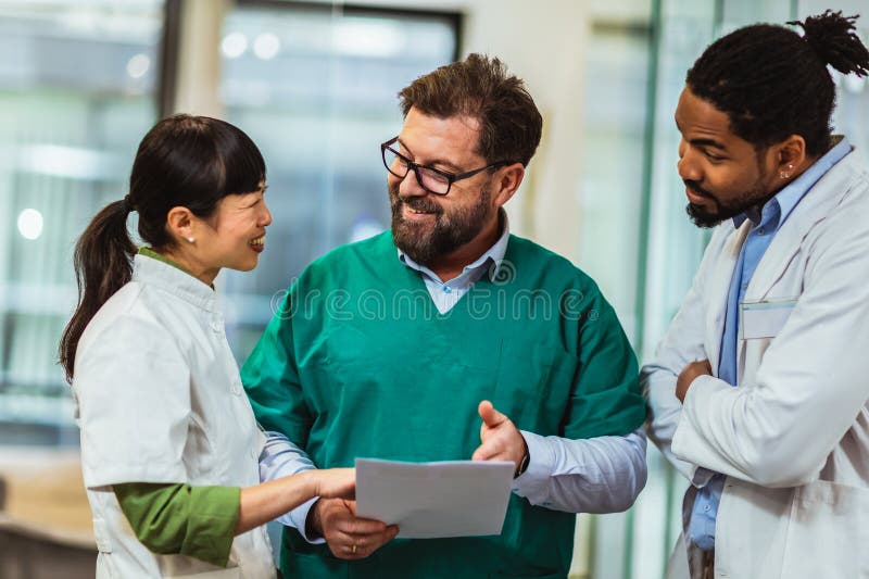 Multiracial Doctors Standing and Discussing about Results Stock Image ...