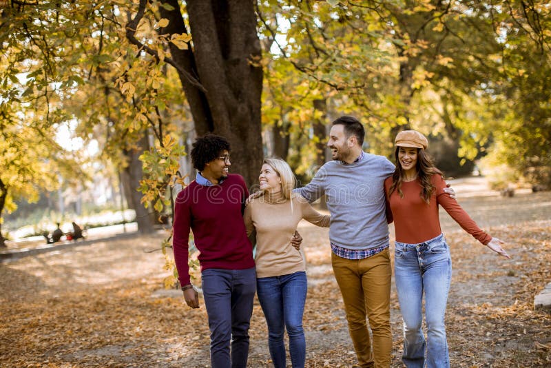 Multiracial Young People Walking in the Autumn Park and Having Fun ...
