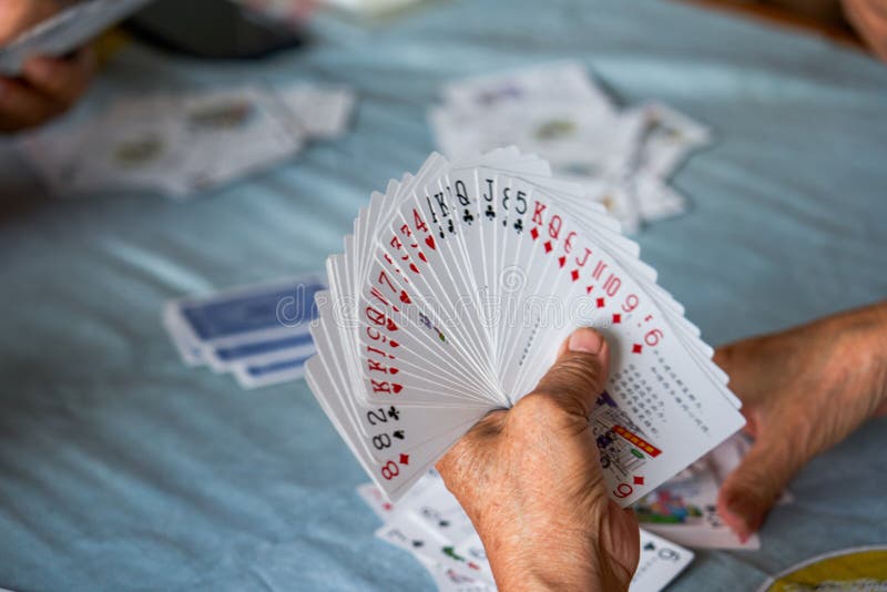 A Group of Old People Sit Around and Play Poker Card Stock Photo ... A Group of Old People Sit Around and Play Poker Card Stock Photo ...