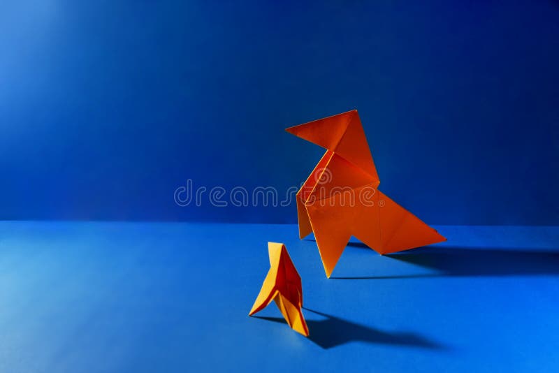 Group of Orange Origami Figures on Blue Background Stock Image - Image ...