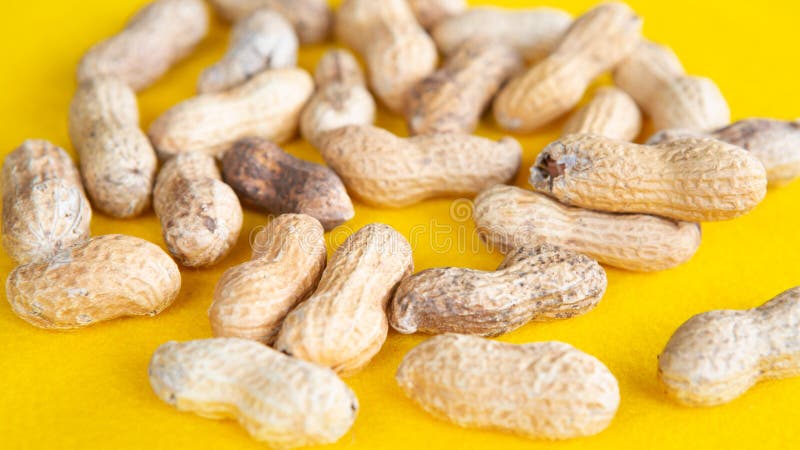 Group of Peanuts on Yellow Plate Stock Photo - Image of shell, nutrient ...