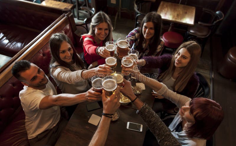 Group of People Celebrating in a Pub Drinking Beer Stock Image - Image ...