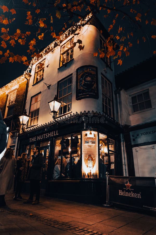Group of People Chatting by the Nutshell the Smallest Pub at Night with ...