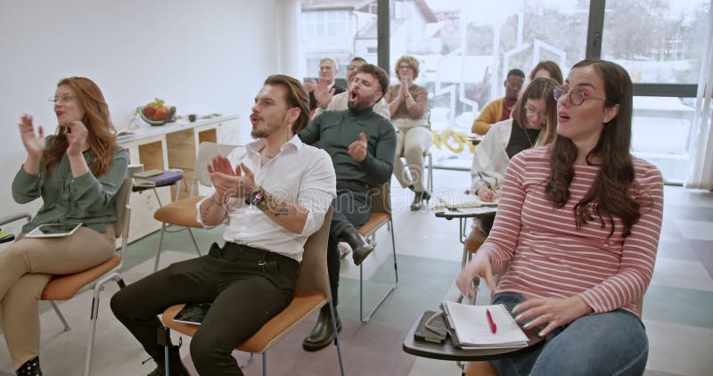 A Group of People Clapping in a Meeting, Showing Appreciation and ...