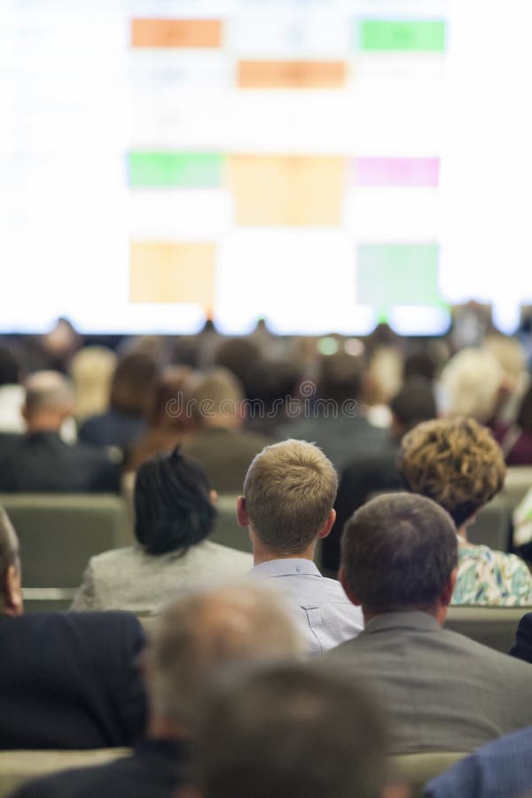 Group of People at the Conference Watching Presentation Charts ...