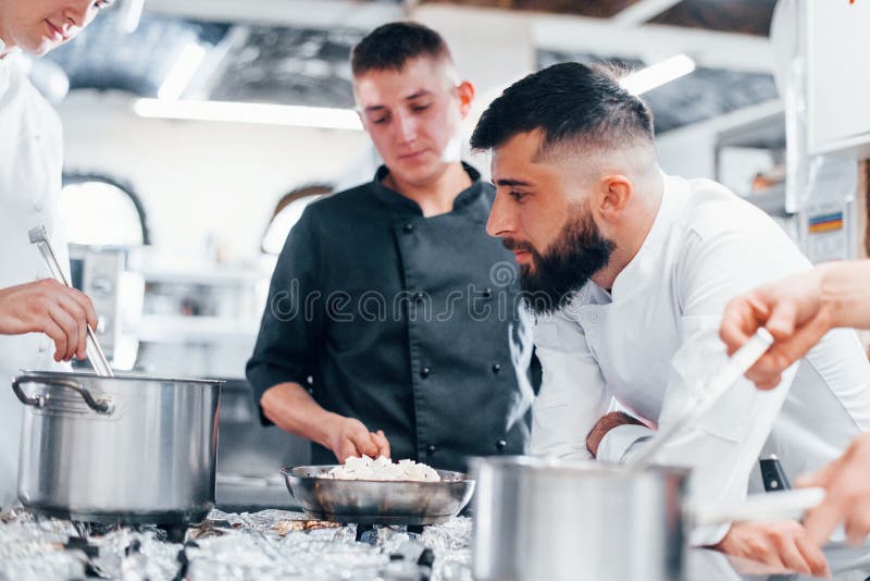Joyful Group Preparing Fresh Ingredients Together in a Cozy Kitchen ...